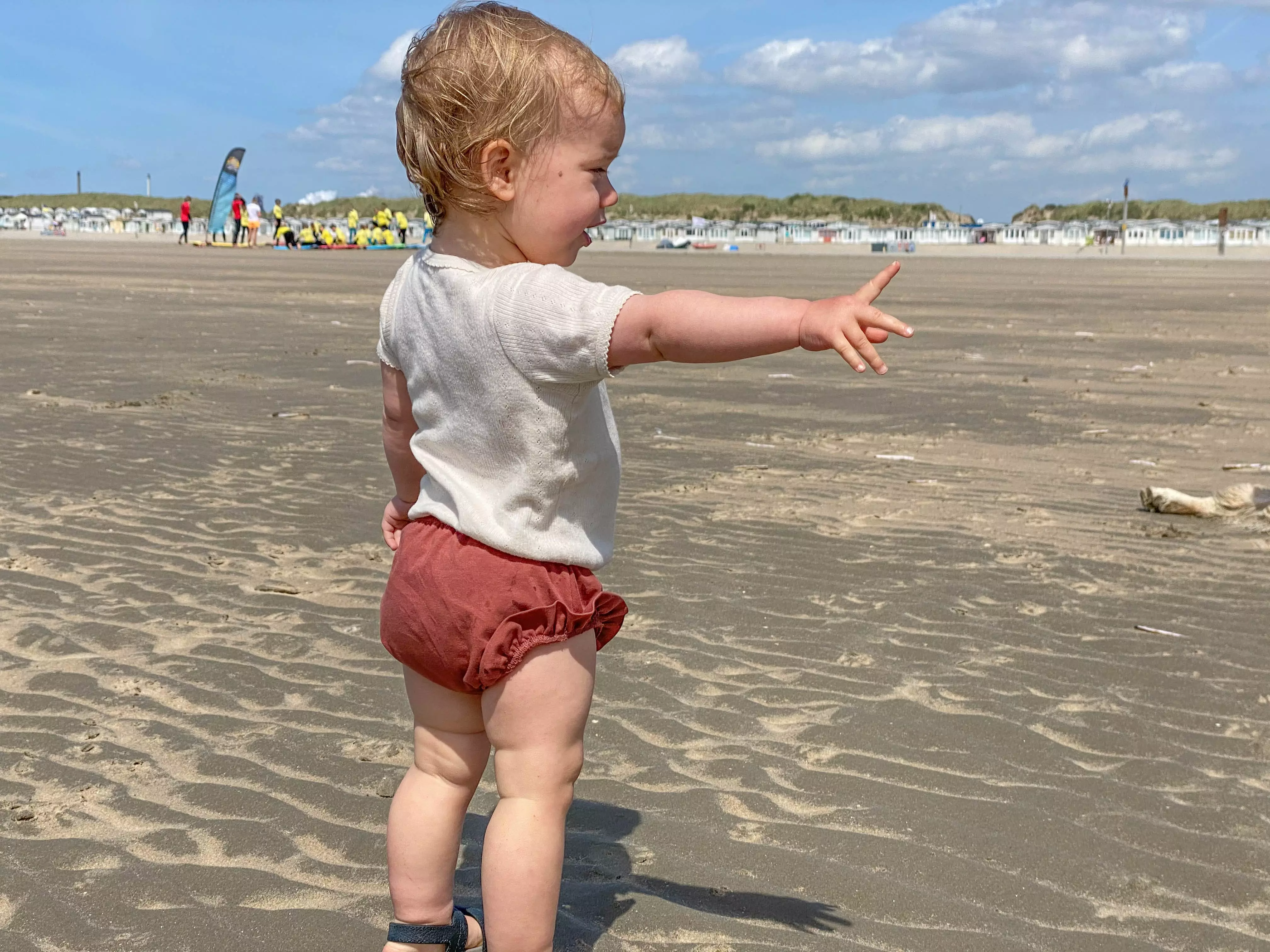 Jentebarn på IJmuiden-stranden på en varm solskinnsdag